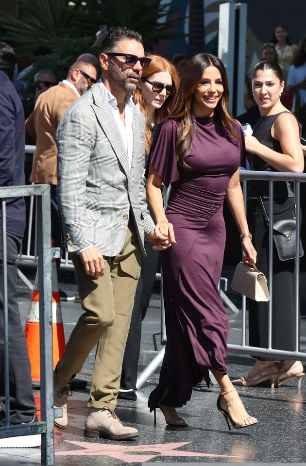 Eva Longoria stuns in a sleek, eggplant-purple wrap dress and illusion ...