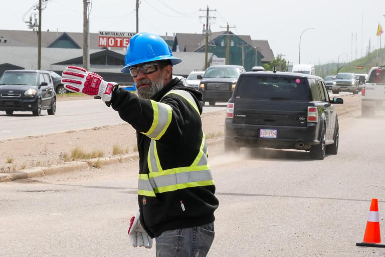 Frustrated Fort McMurray residents fill Highway 63 potholes themselves