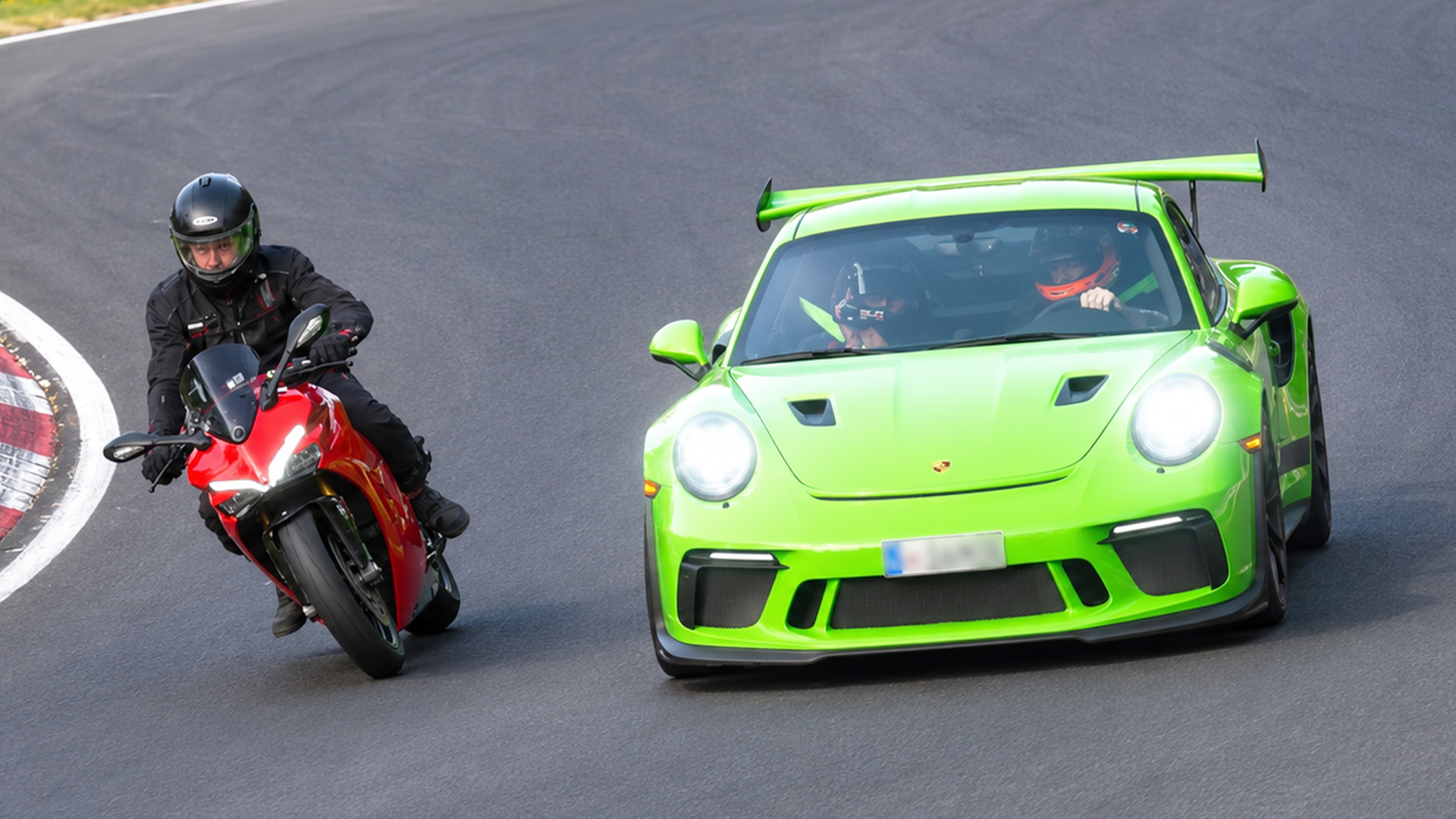 Performance cars and bikes meet on a demanding circuit