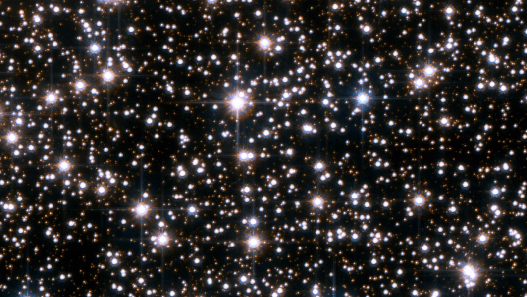 Hubble captures galaxy cluster bending light from distant universe