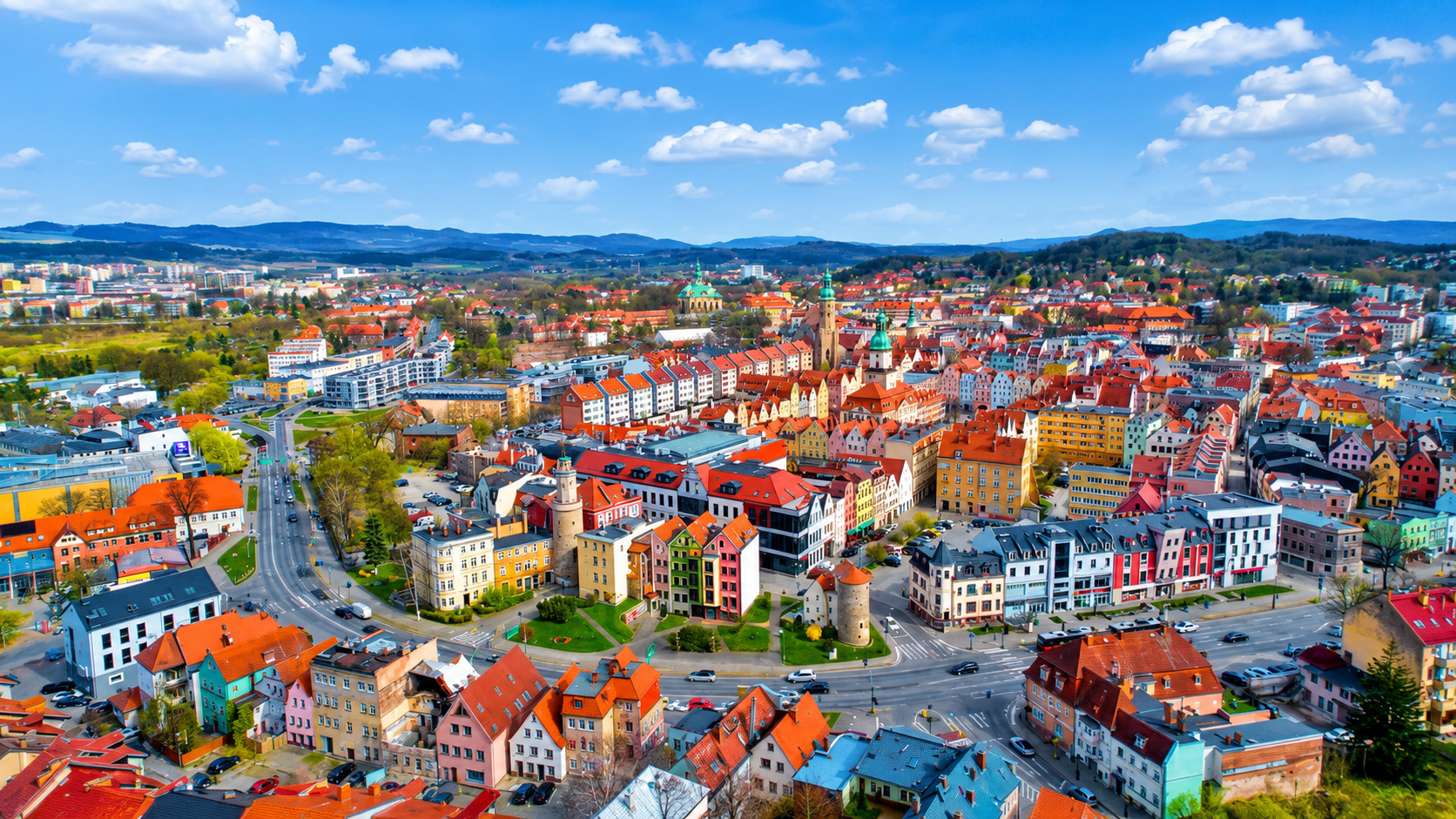 A colorful Polish old town beneath the Karkonosze Mountains