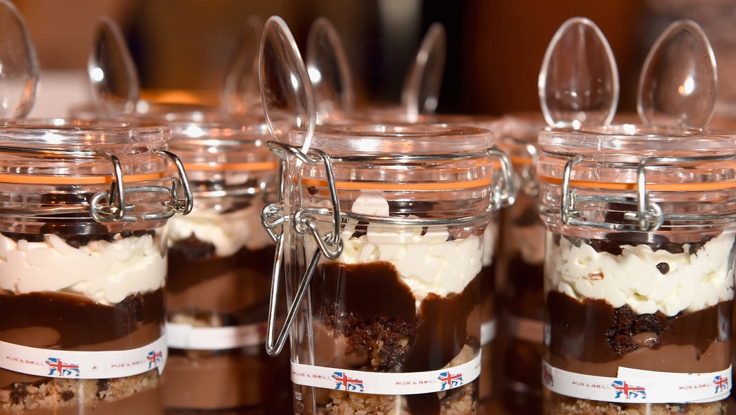Layered chocolate trifles with cakes, brownies, and cream