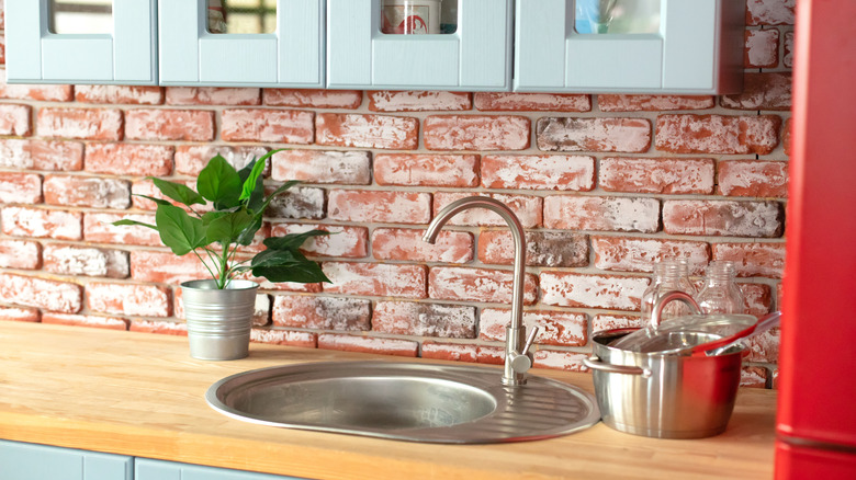 Give brick kitchens a bold revival with one gorgeous cabinet color