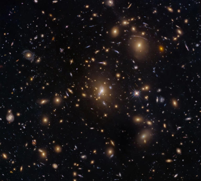 Hubble captures a cosmic swarm that is bending light across the universe