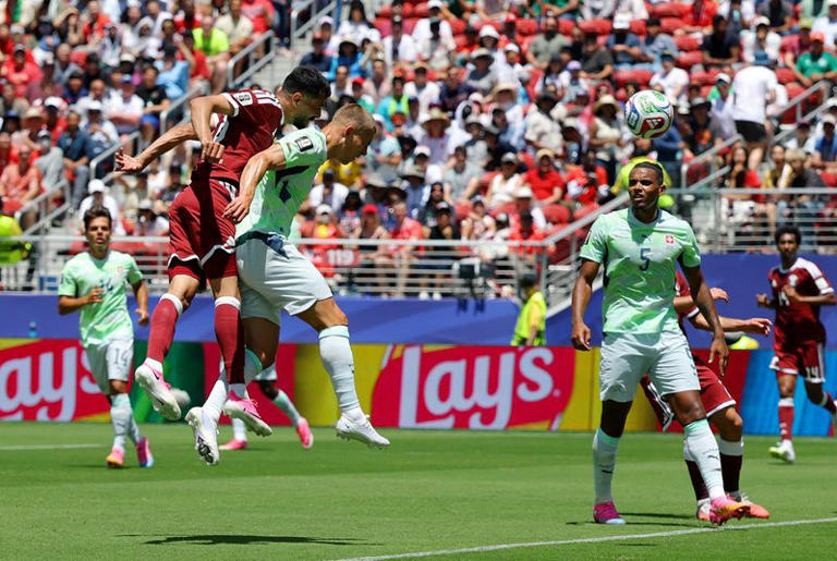 Soccer-Qatar score late to clinch draw with stunned Switzerland