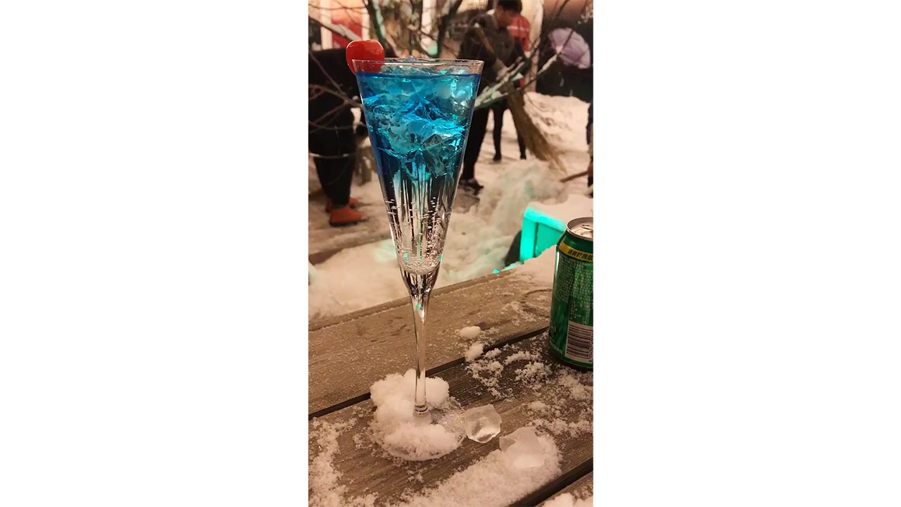 Crafting crystal blue winter cocktail with cherry garnish, creating ...