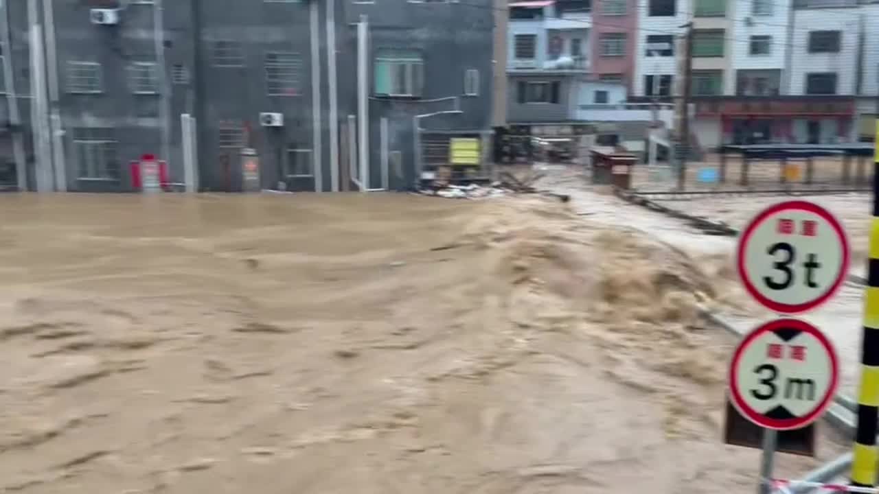 Bridge submerged as severe flooding inundates Shuangjiao Town in ...
