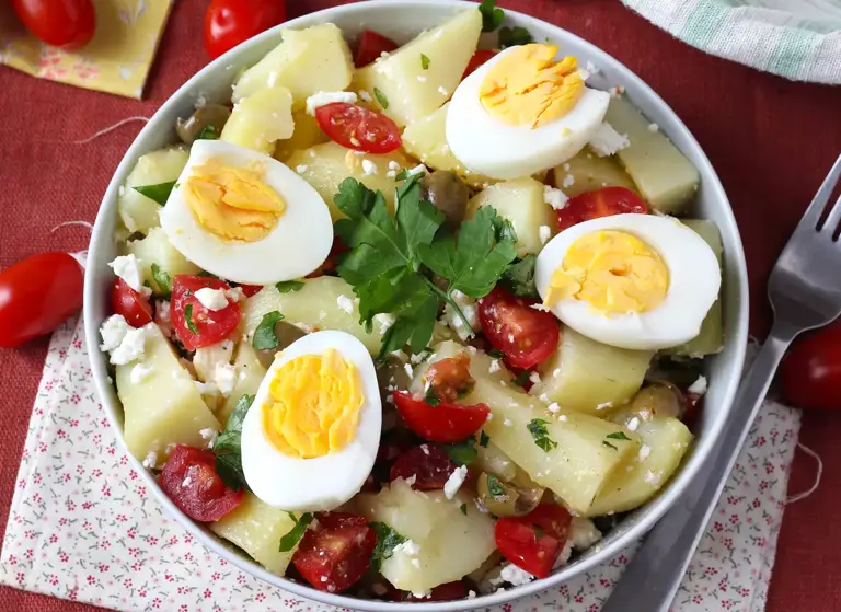 Potato salad with feta cheese, egg, and cherry tomatoes