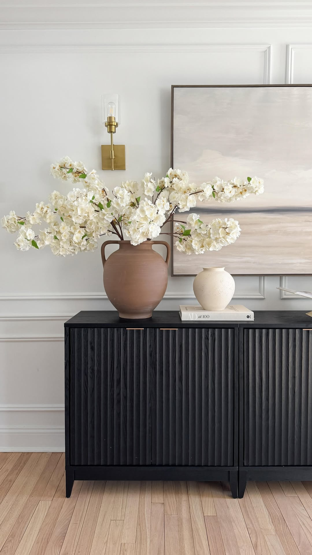 Adding texture and contrast with black fluted consoles