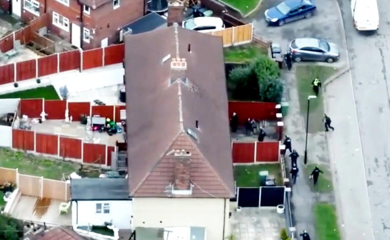 Moment cops storm fortified drugs den run by family crime gang