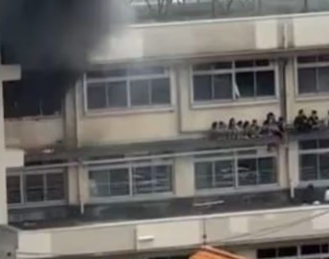 Children hold on for their lives after fire forces them onto ledge
