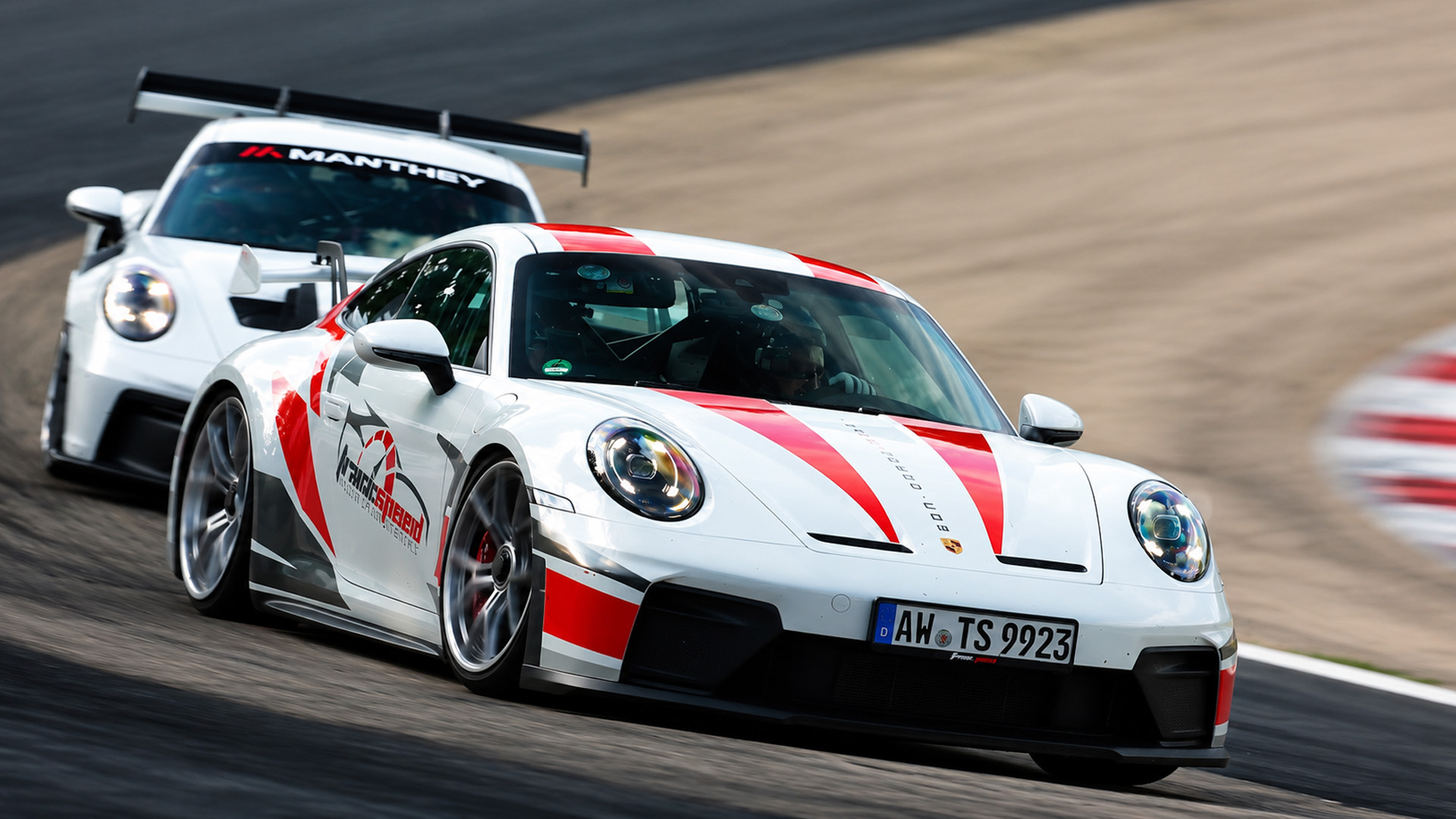 Two Porsche track cars fight through the corner