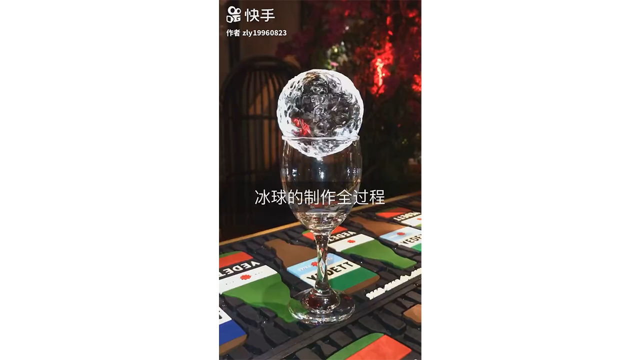 Carving crystal clear ice sphere for cocktail glass, creating premium ...