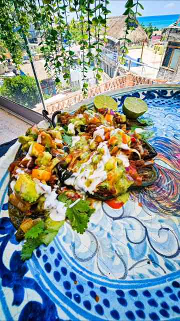 Chorizo-stuffed charred poblanos with avocado-serrano salsa