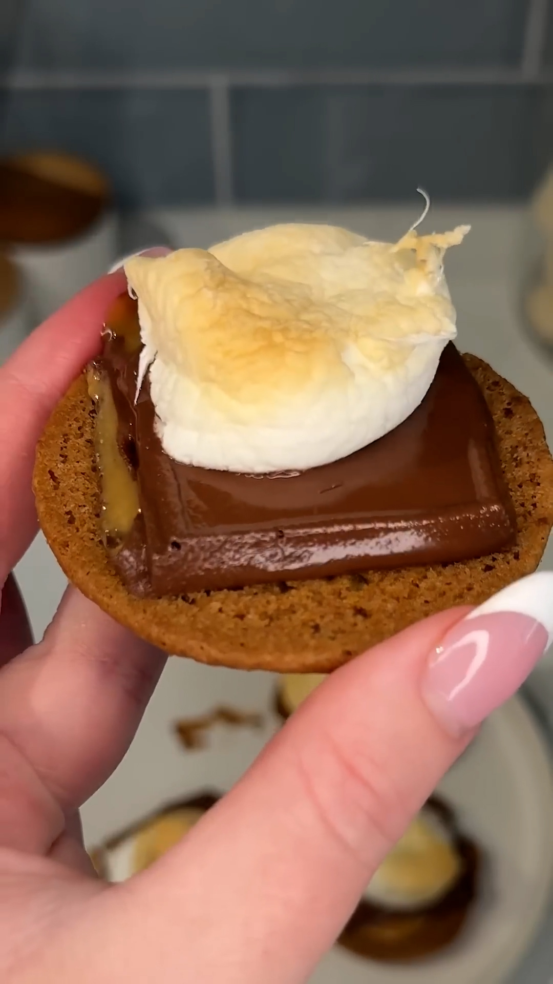 Chocolate chip cookies stacked with melted chocolate and marshmallow