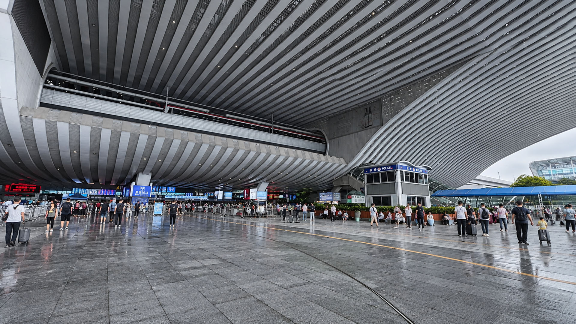 A rainy walk in China ends at a giant train station