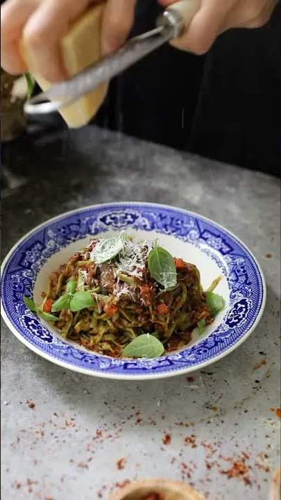 Homemade spinach tagliatelle with rich Bolognese sauce