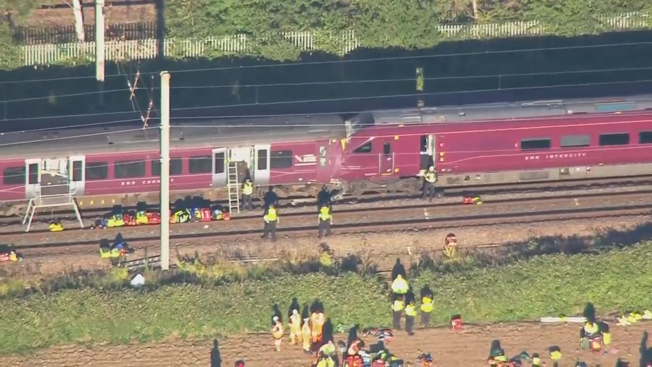 Aerials show emergency workers attending to train collision injured in UK