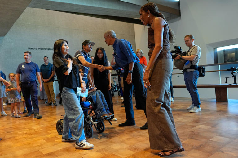 Barack and Michelle Obama surprise first visitors to newly opened ...