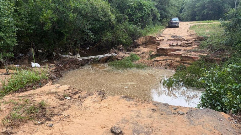 Families cut off after floodwaters wash away only road into neighborhood