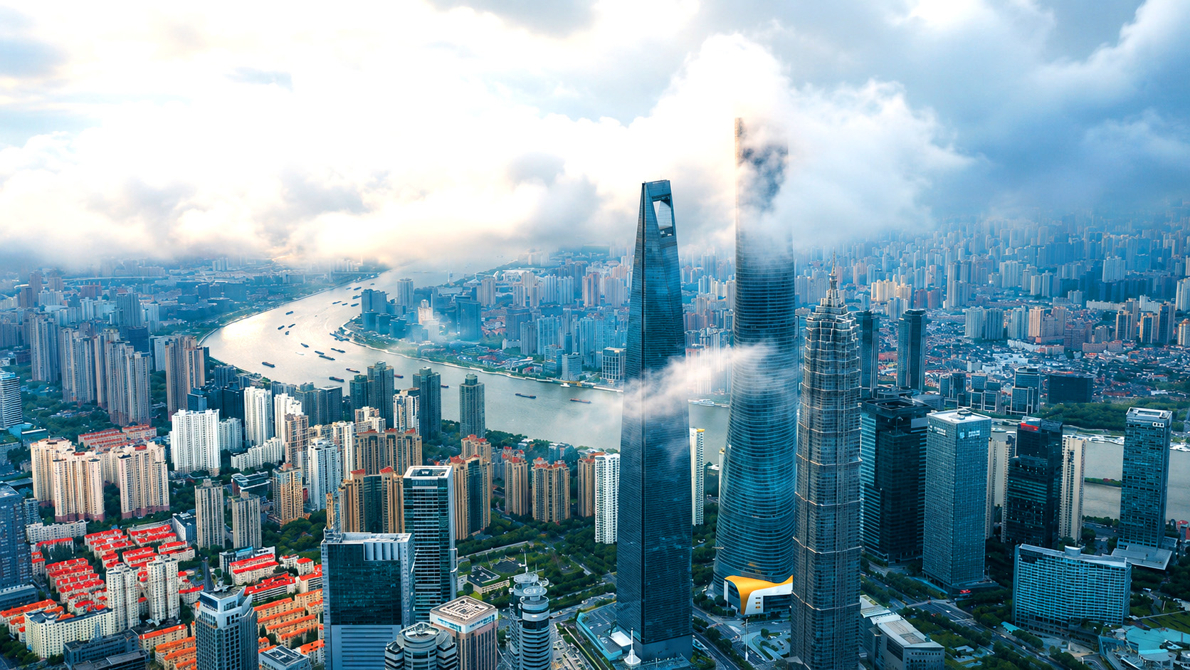 A modern city skyline disappearing into the fog