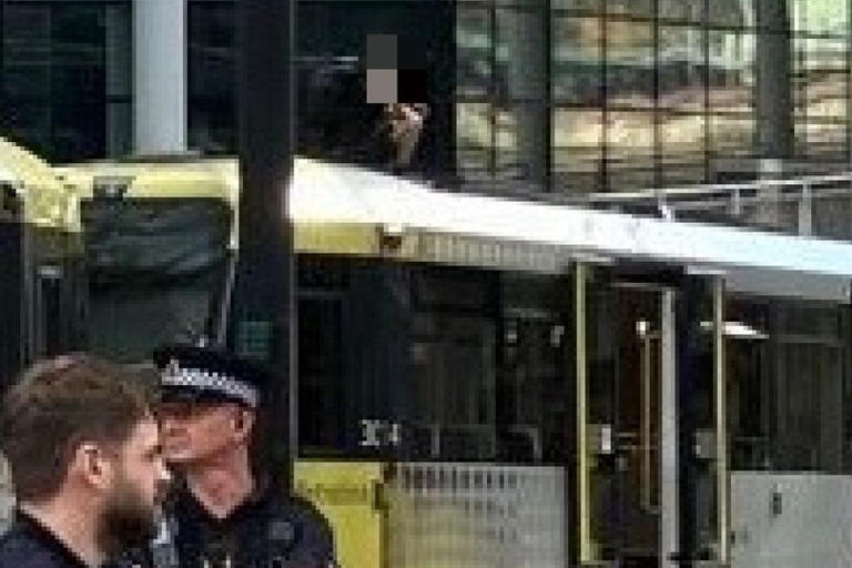 Emergency services descend as man climbs onto roof of Manchester tram