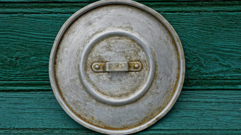 Use an old pot lid to create budget-friendly garden art with a clever DIY