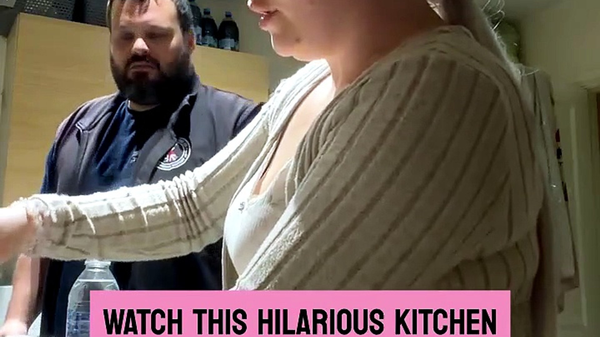 The woman jumps in shock when her brother's water bottle prank hits