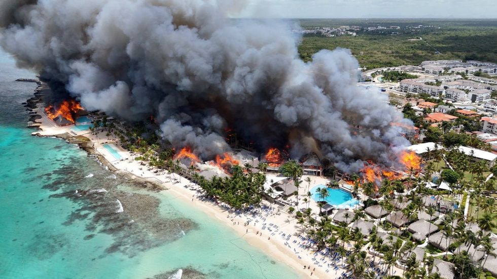 Tourist dies after fire rips through luxury beach resort as 1,700 ...