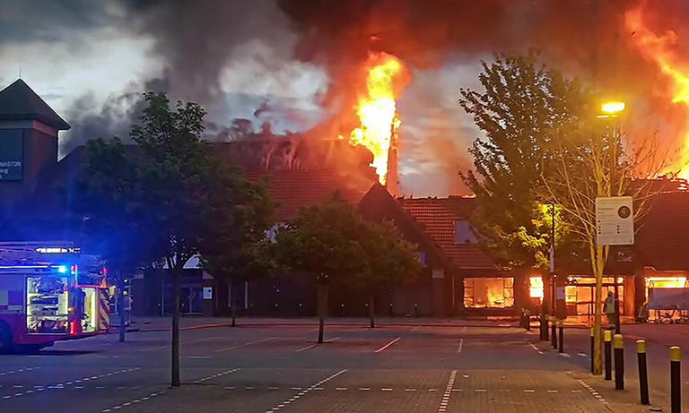 Massive blaze rips through shopping centre as roof collapses and ...
