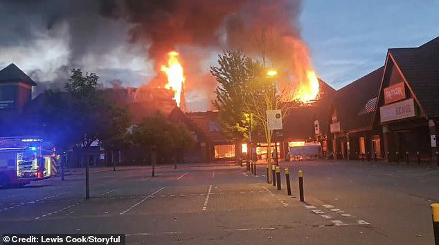 Massive blaze rips through shopping centre as roof collapses and ...
