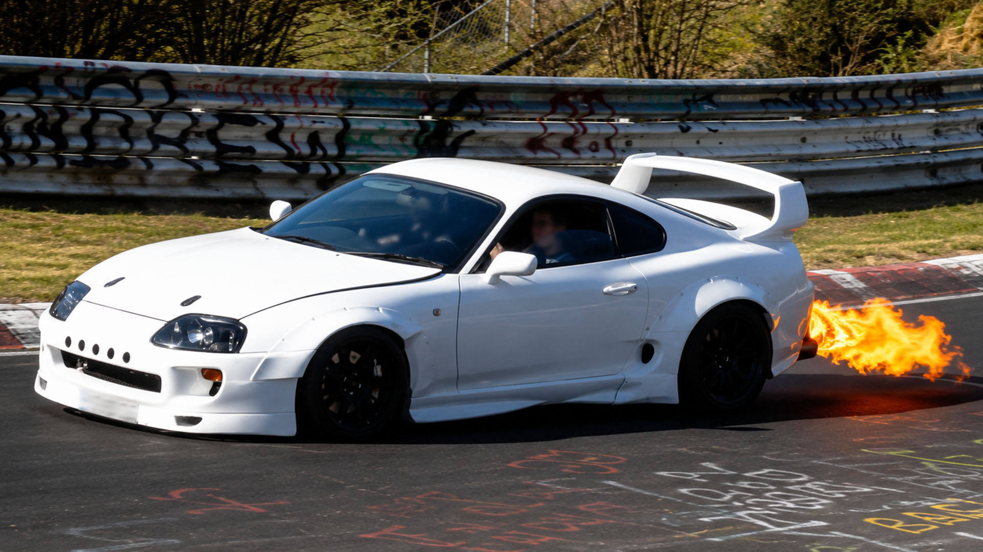 Massive exhaust flames light up the Nordschleife straight