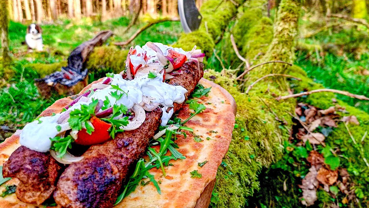 Watch how lamb kebabs and naan bread cook in the forest