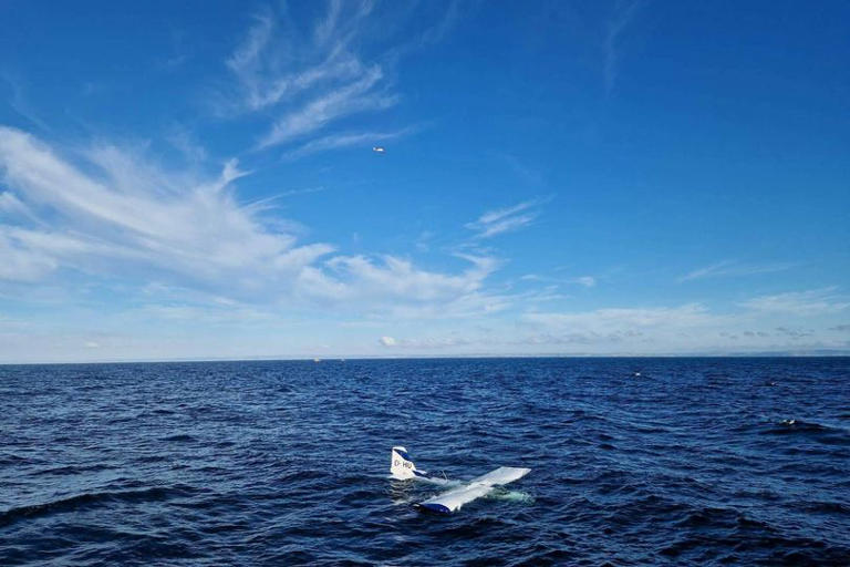 Plane crash horror as crew found floating on wing after crashing into ...