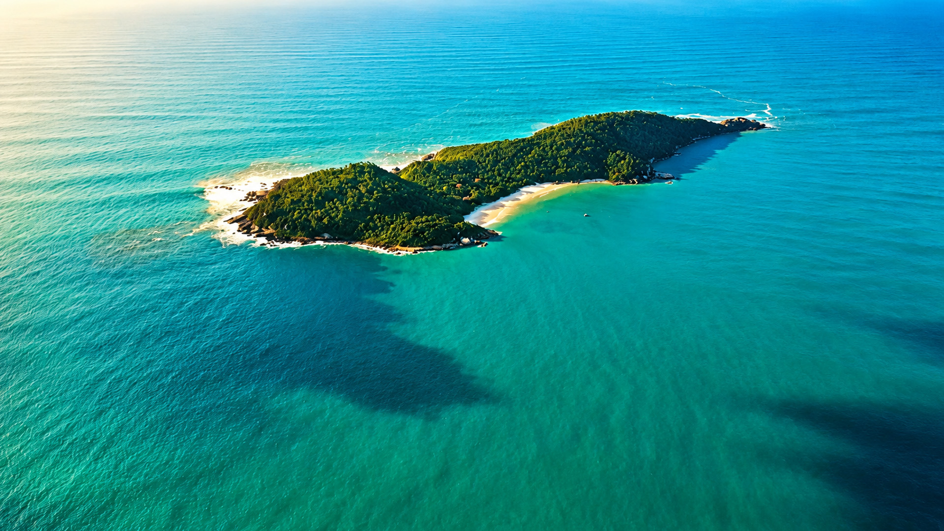 A tiny island floating alone in crystal clear blue water
