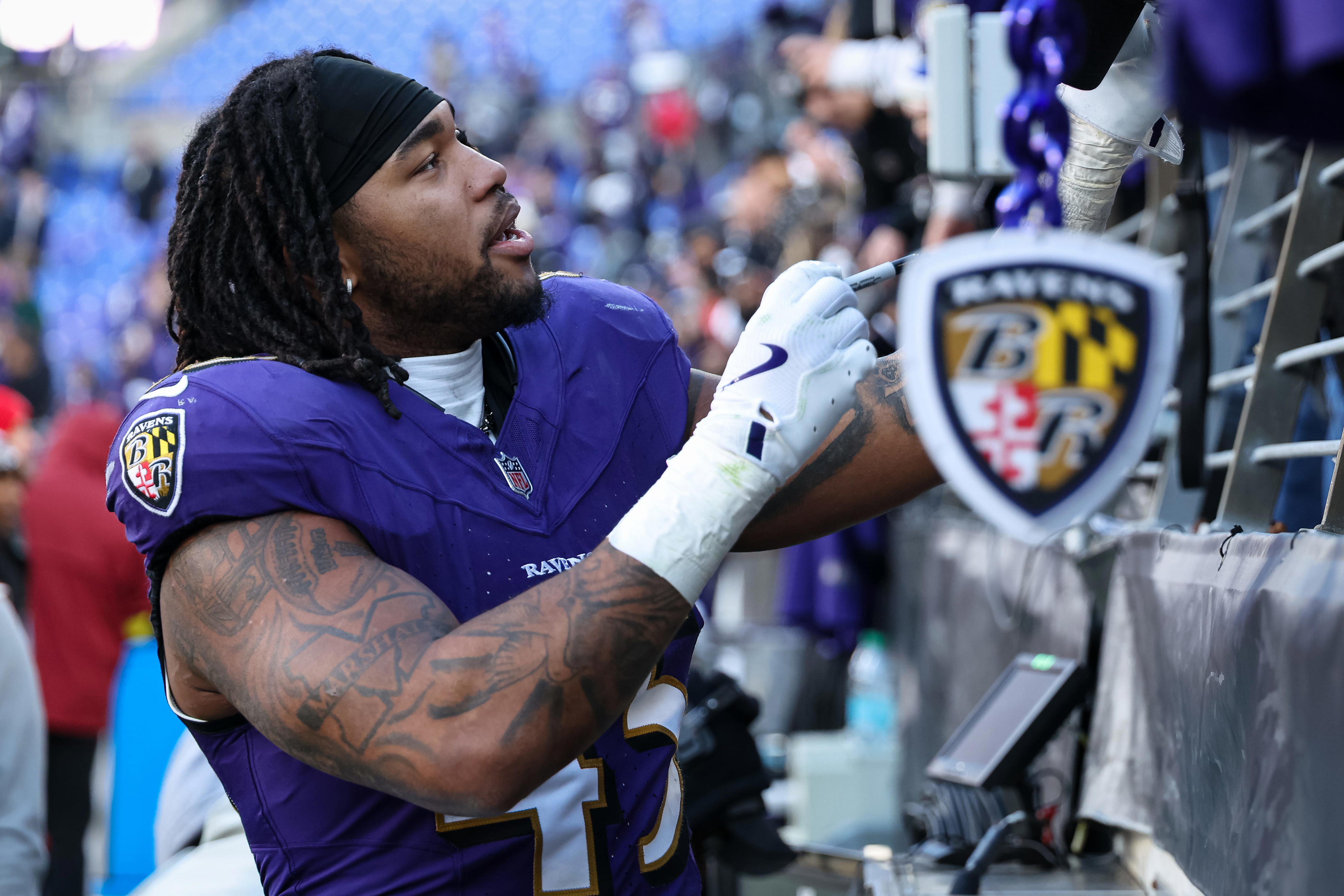 Ravens pass rusher Mike Green tests himself against a sumo wrestler