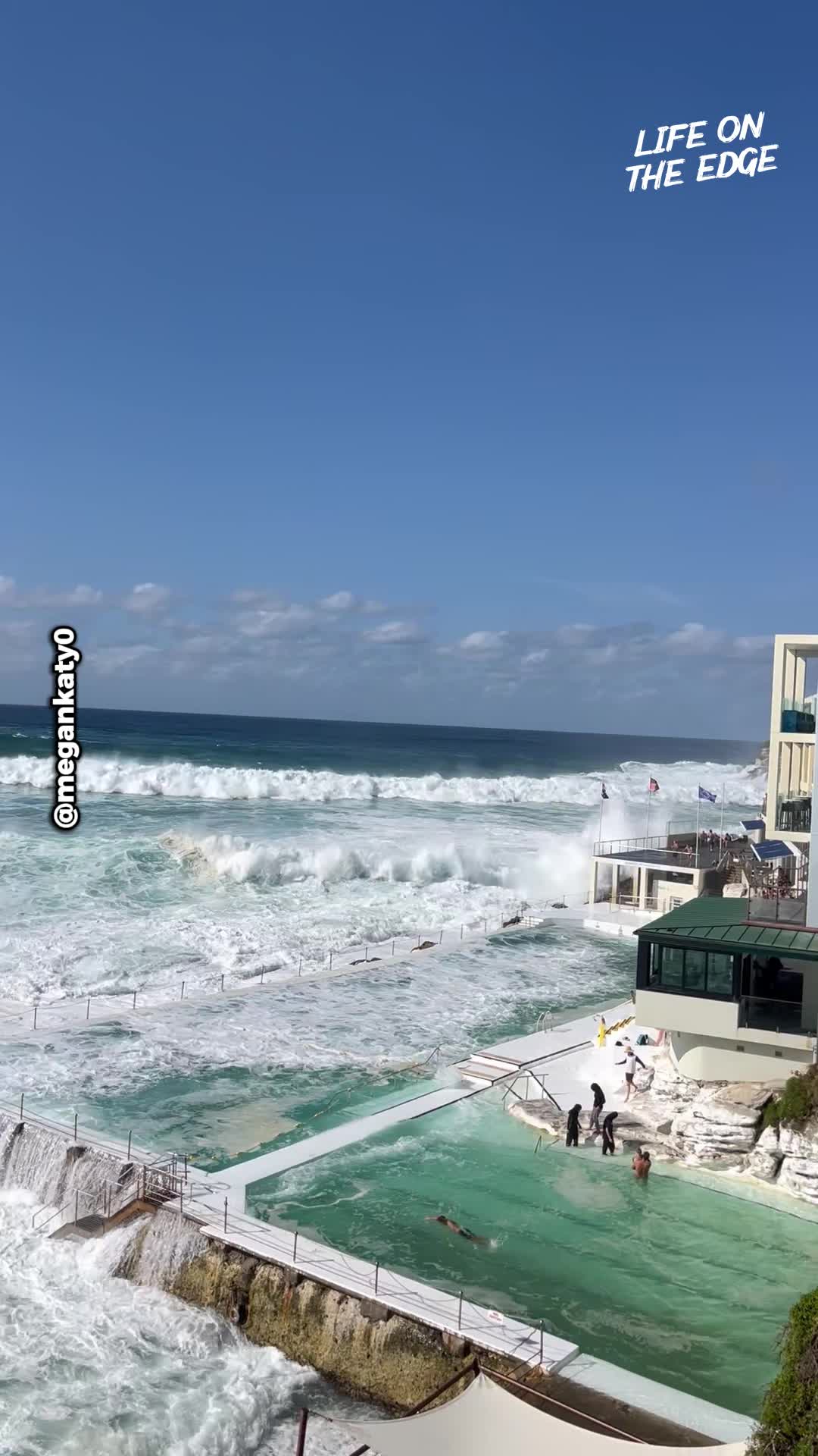 Powerful wave crashes into swimmers at famous beach
