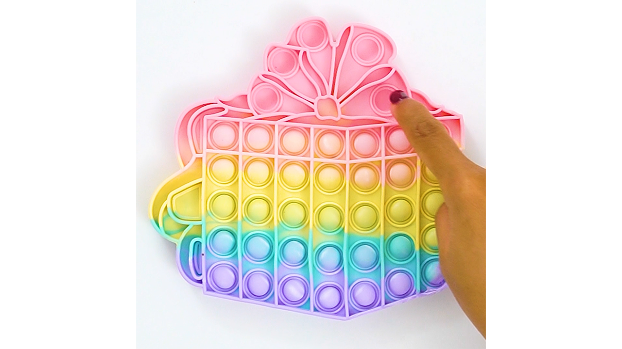 Pressing a rainbow gift box pop it with smooth bubble texture