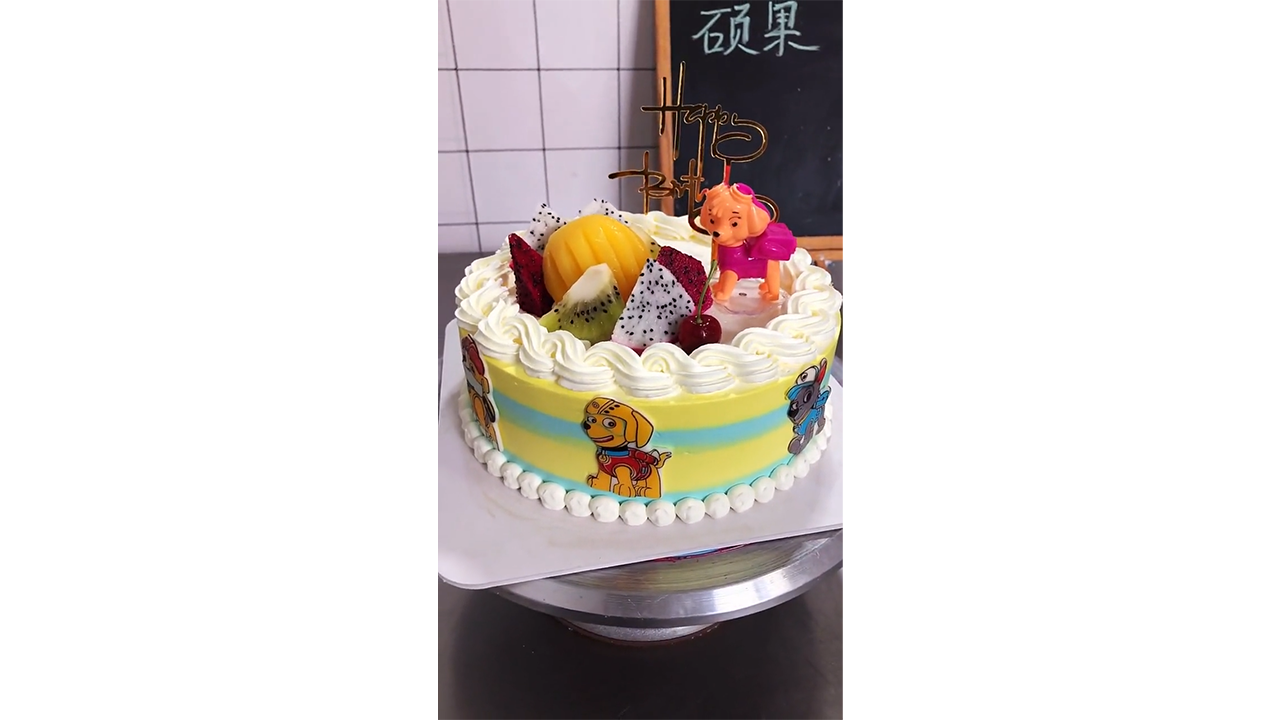 Creating Paw Patrol adventure cake with Skye topper and fresh fruit display