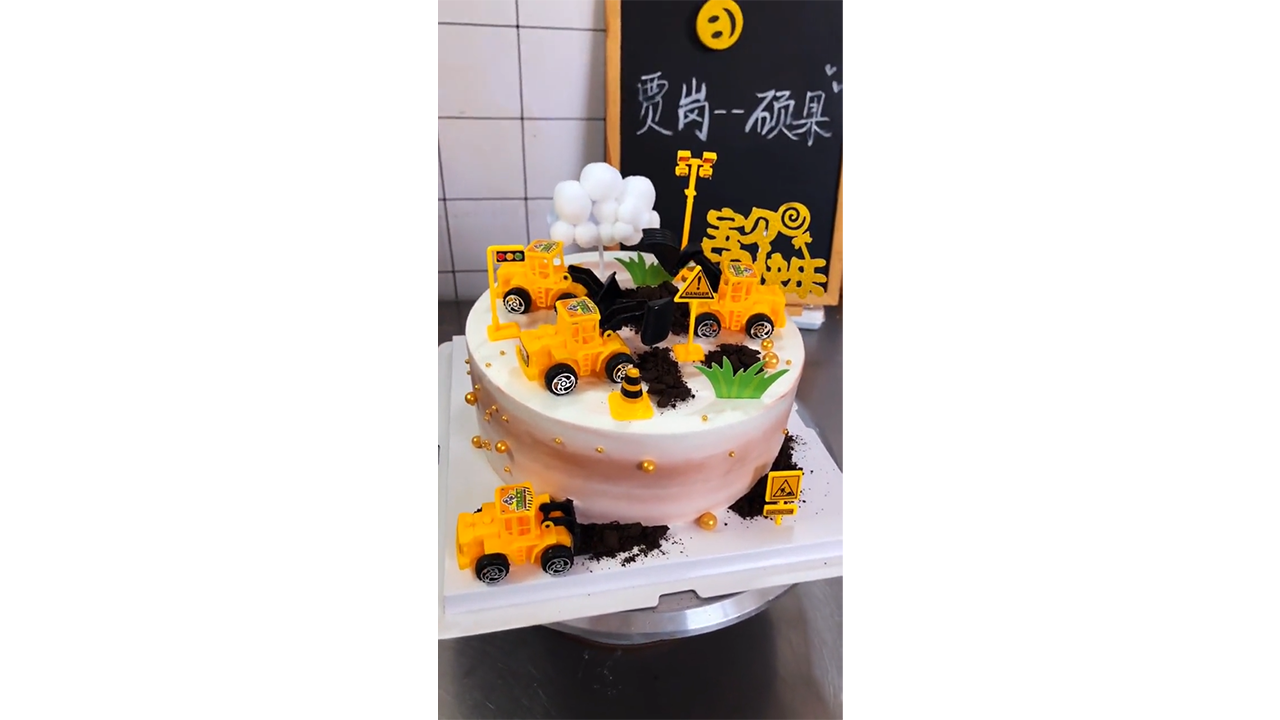 Constructing mini construction site cake with excavators and dirt path ...