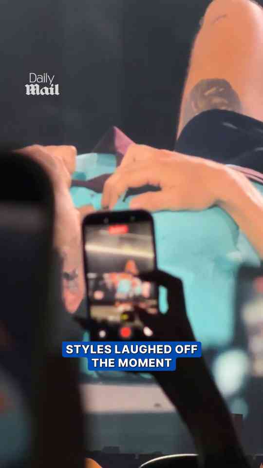 Harry Styles briefly falls on stage after appearing to choke on water