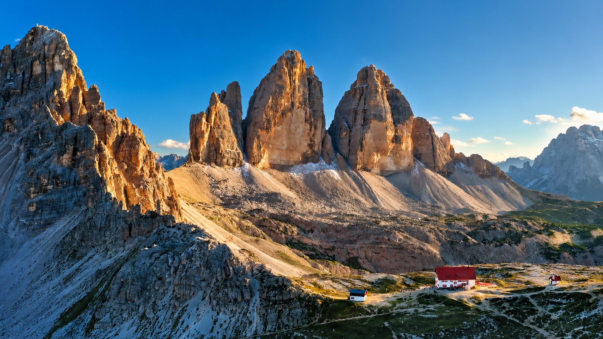 A mountain shelter beneath massive cliffs