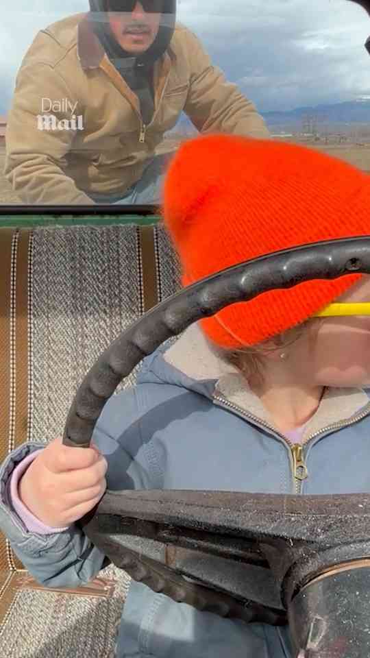 Little farm helper lends a hand behind the wheel