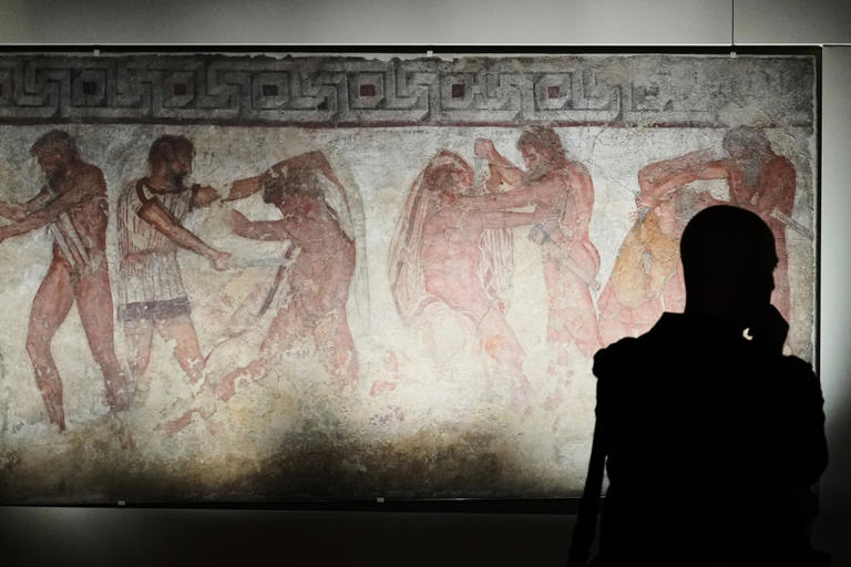 Italy displays paintings from an ancient Etruscan tomb, its latest ...