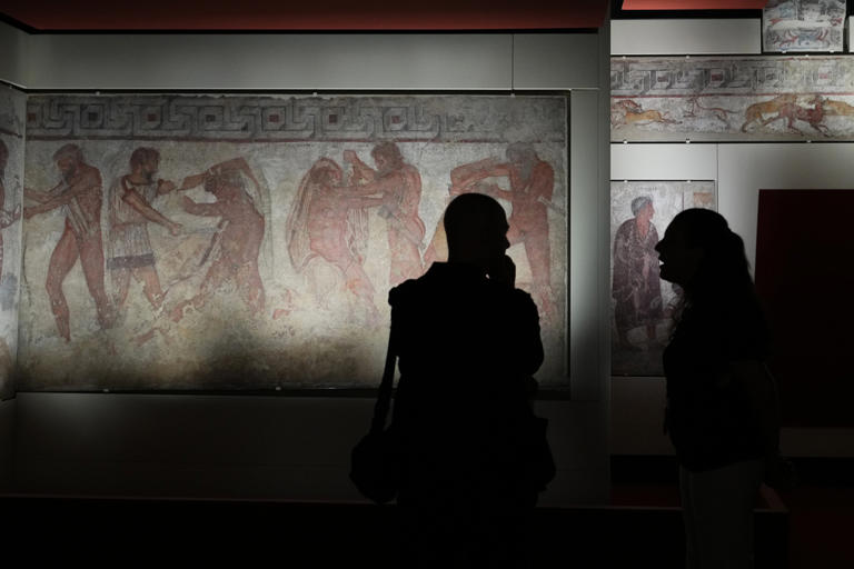 Italy displays paintings from an ancient Etruscan tomb, its latest ...