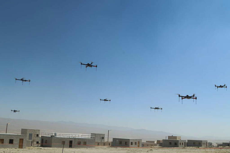Explorative PSO for drone swarms in occluded target tracking