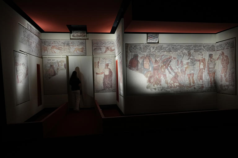 Italy displays paintings from an ancient Etruscan tomb, its latest ...