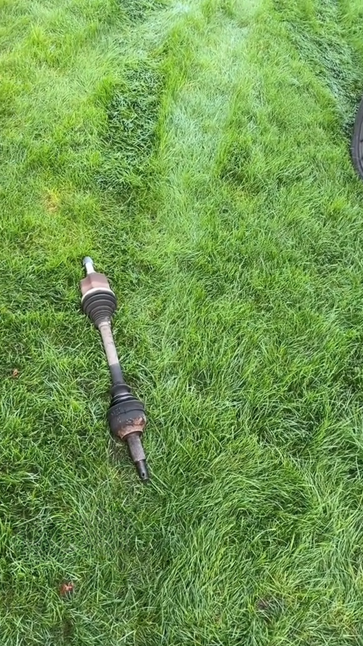 Inspecting a sheared CV axle pulled from a broken vehicle