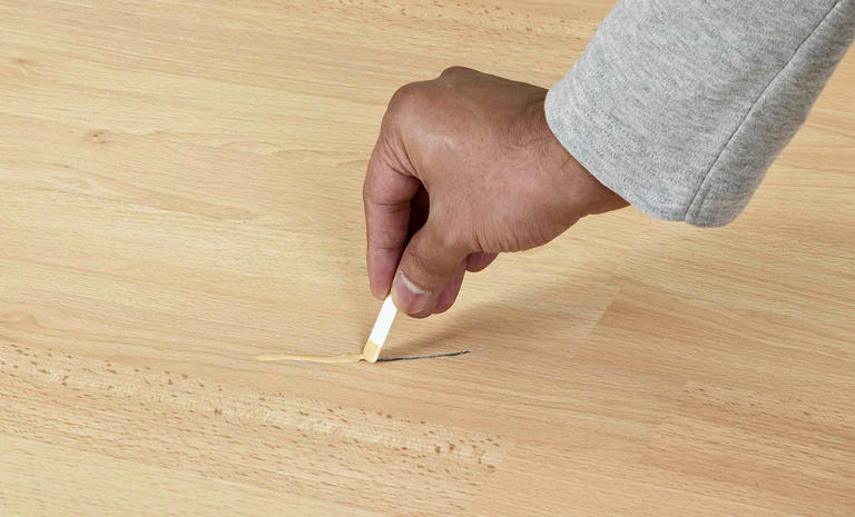 How to fix scratches on laminate floors without replacing them