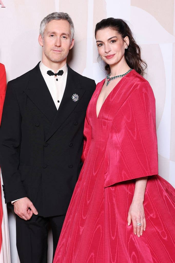 Anne Hathaway shows off blossoming baby bump in bold red look
